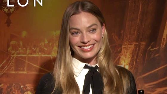 Margot Robbie Reacts To Kissing Brad Pitt Exclusive